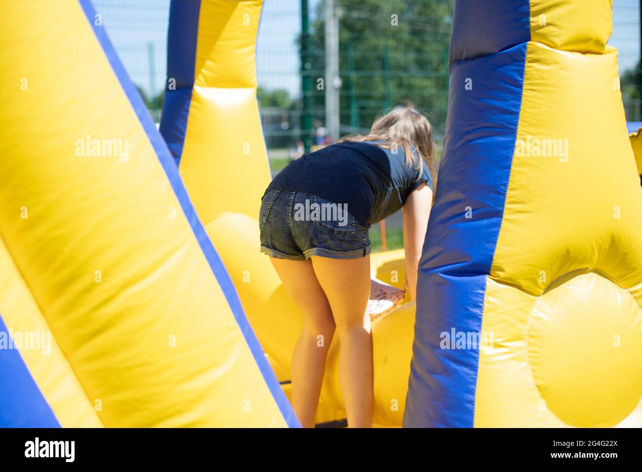 Children climb an inflatable slide. Inflatable obstacle course for fun ...
