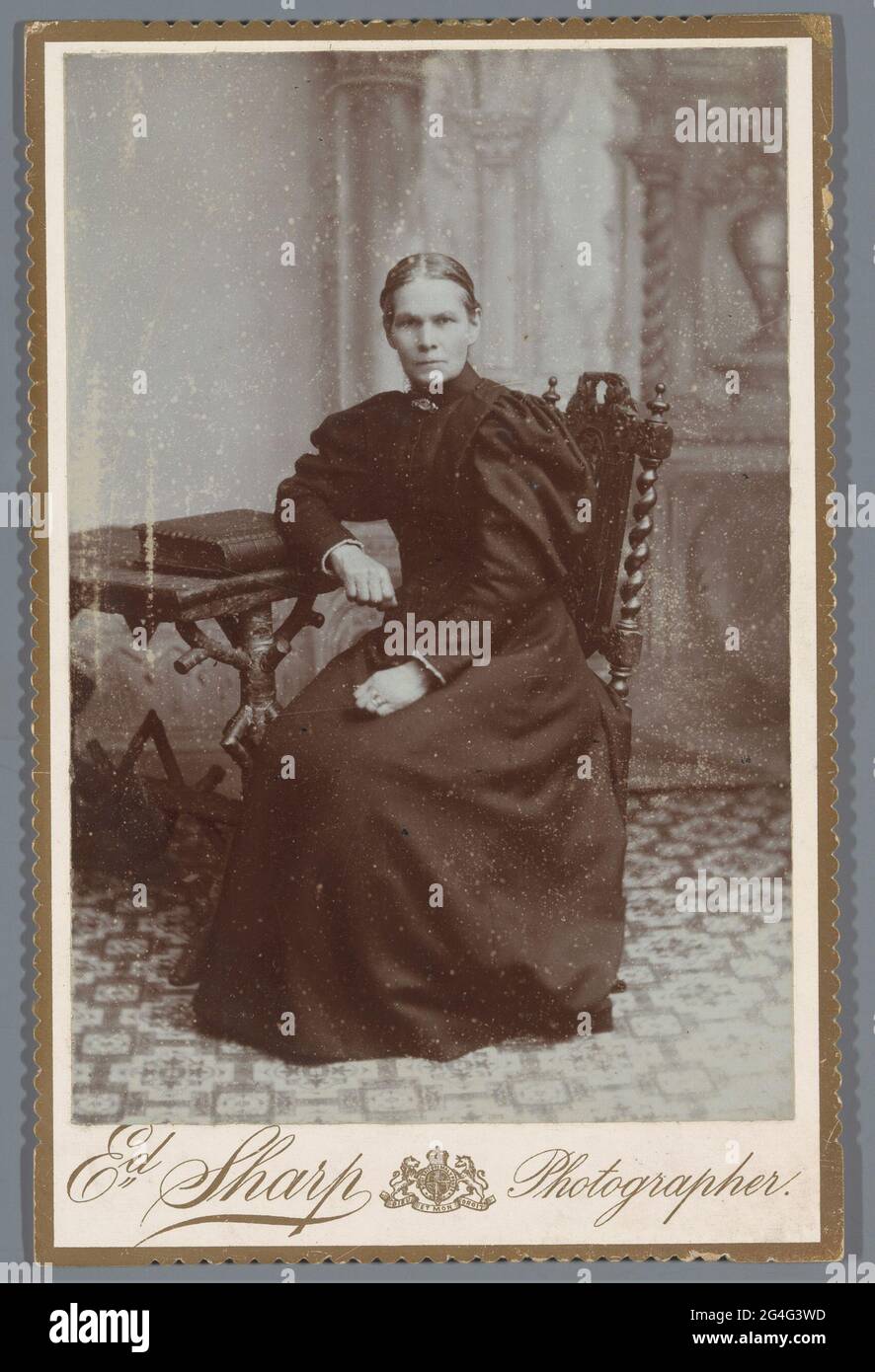 Studio portrait of a sitting woman Stock Photo - Alamy