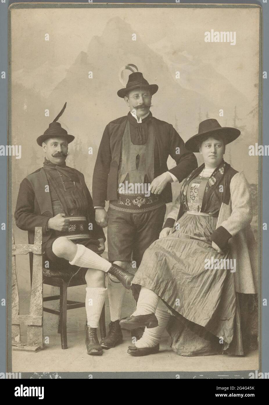 Group portrait of two men and a woman in Tyrolean traditional costume ...