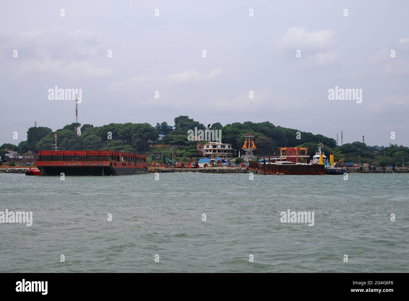 BATAM, INDONESIA - Aug 06, 2019: Large Cargo Barge is on the beach dock ...