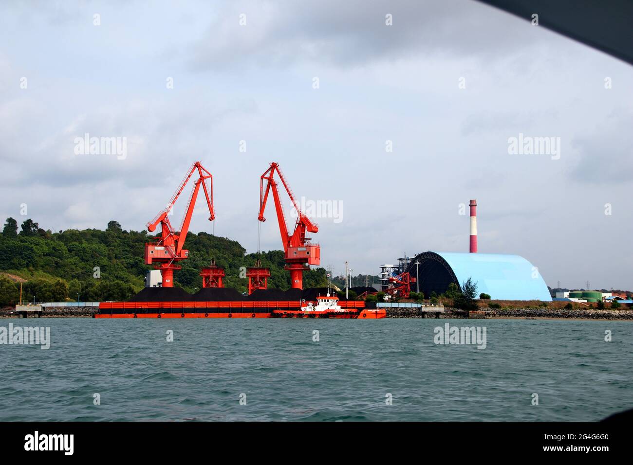 BATAM, INDONESIA - Aug 06, 2019: Large Cargo Barge is on the beach dock ...