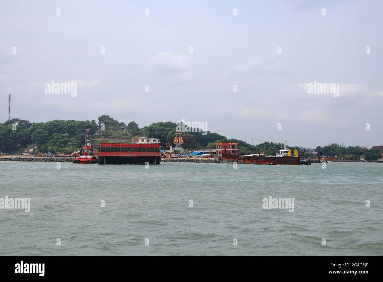 BATAM, INDONESIA - Aug 06, 2019: Large Cargo Barge is on the beach dock ...