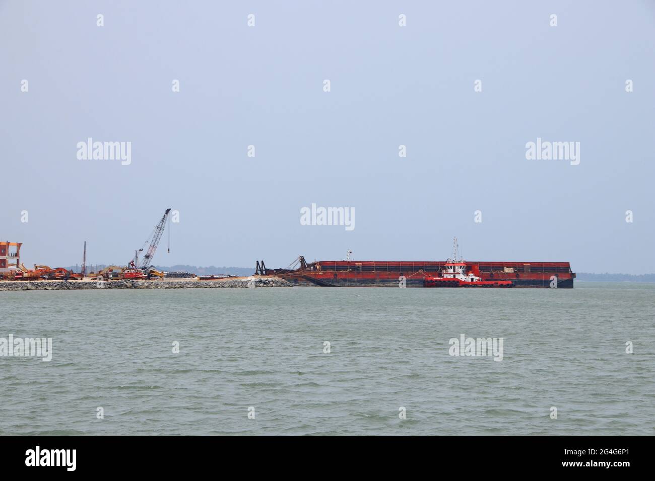 BATAM, INDONESIA - Aug 06, 2019: Large Cargo Barge is on the beach dock ...