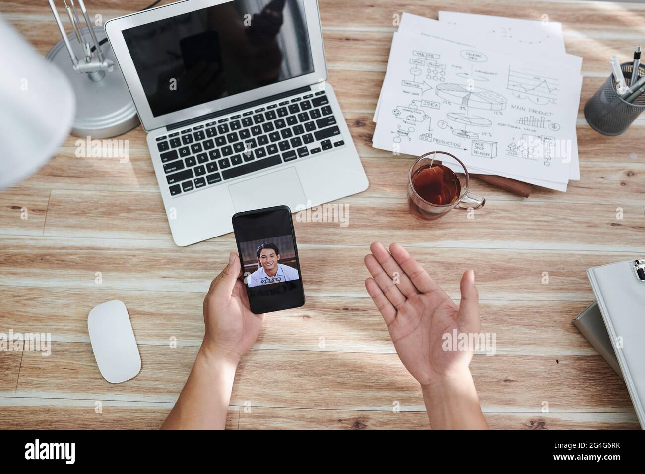 Business person with smartphone actively gesturing when making video ...