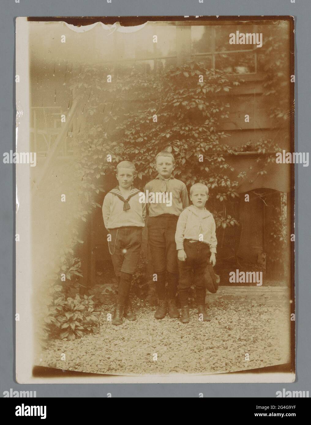 Portrait of three unknown boys in a garden Stock Photo - Alamy