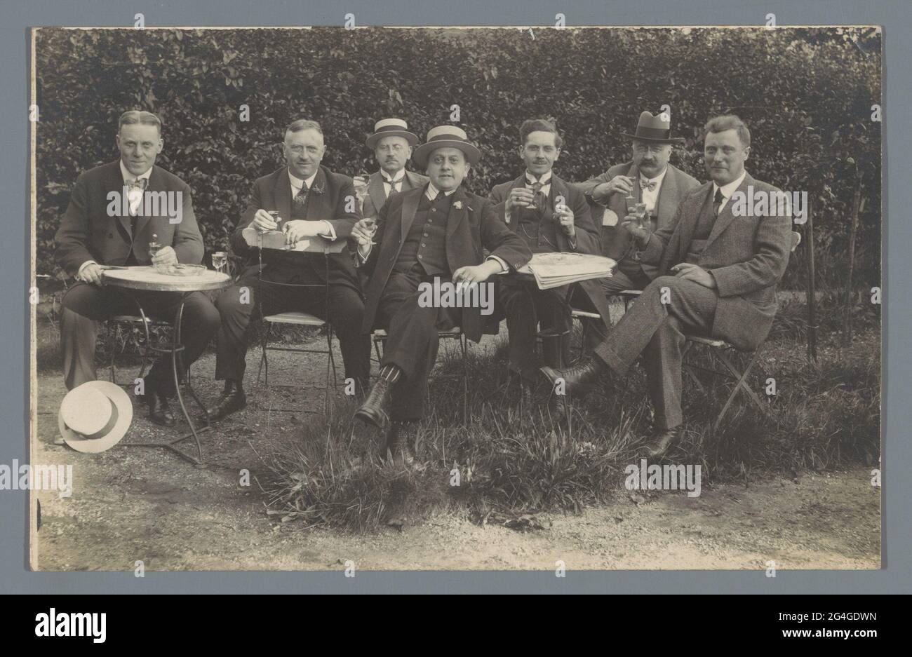 Group portrait of seven unknown men on a gravel path Stock Photo - Alamy