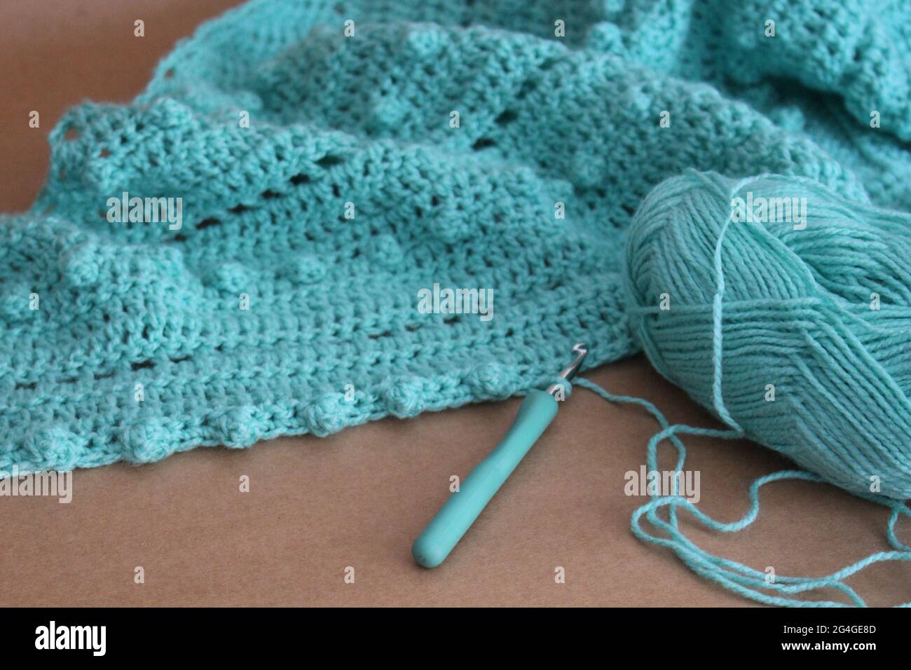 Closeup shot of a blue string in a crochet pattern and tools Stock ...