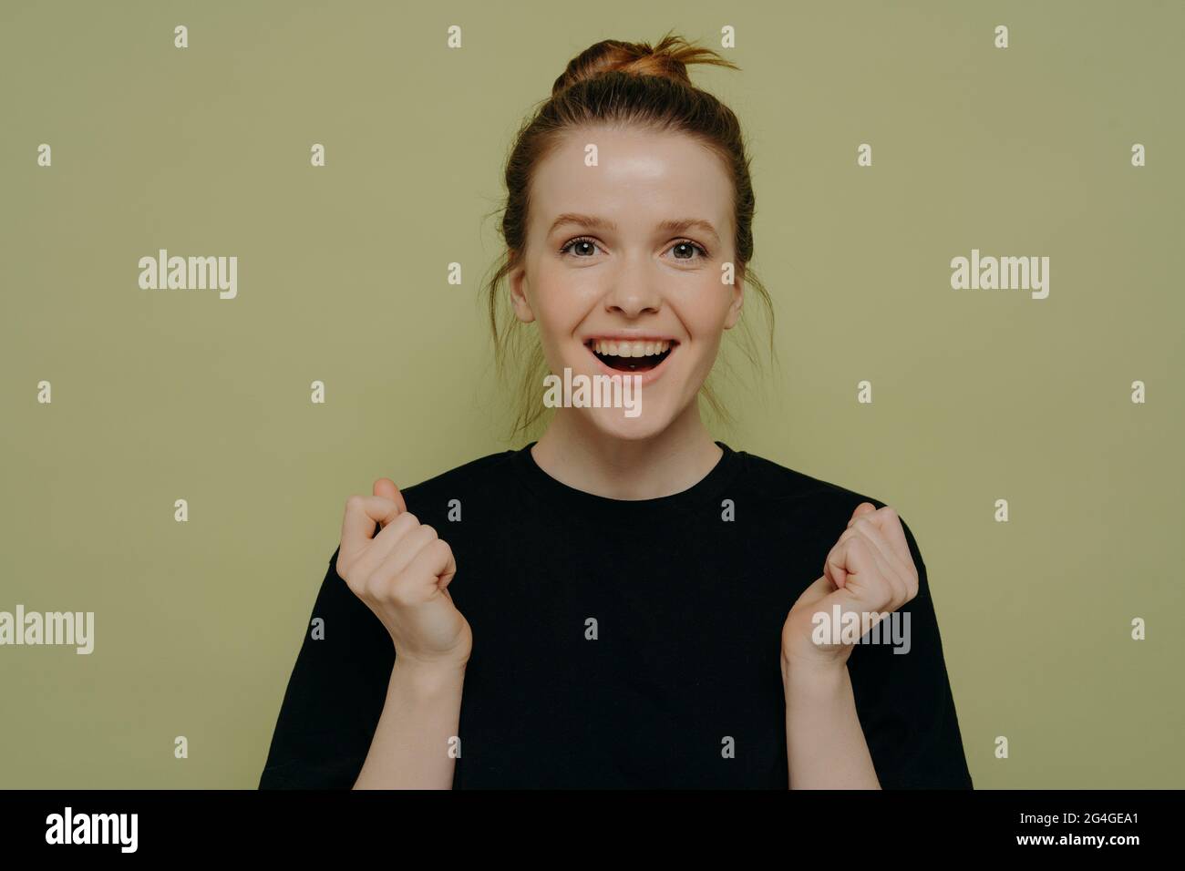 Excited teenage girl posing on green background Stock Photo - Alamy
