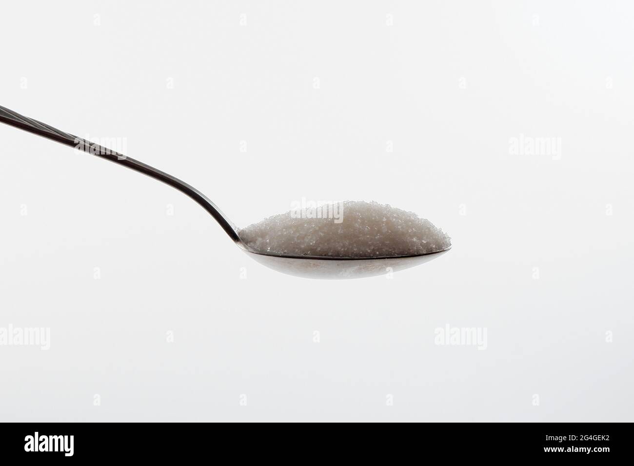 sugar in a spoon, isolated on a white background Stock Photo - Alamy
