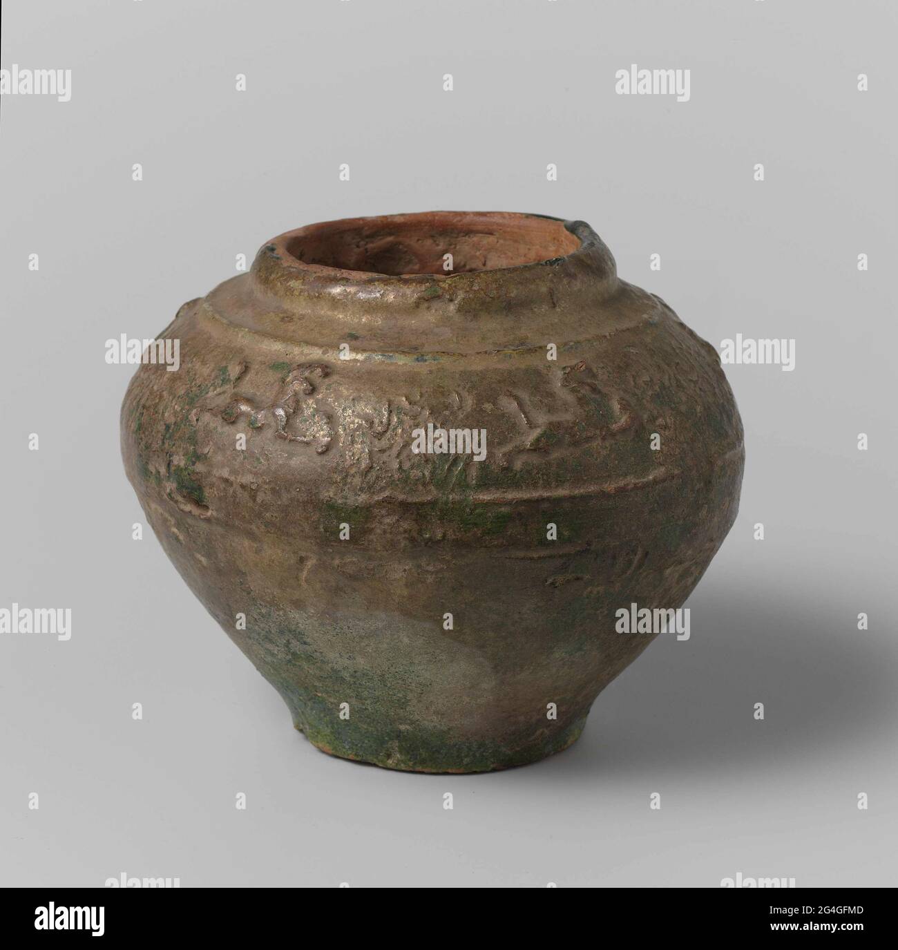 . Egg-shaped pot of pottery, covered with a green glaze. On the ...