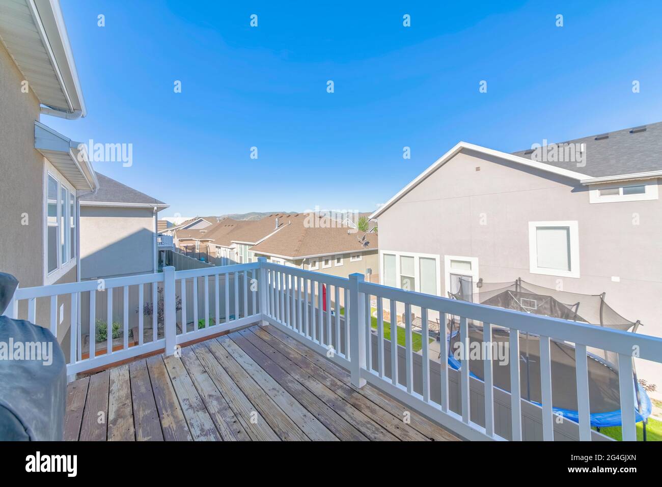 Wooden terrace under a clear blue sky with a view to the neighborhood ...