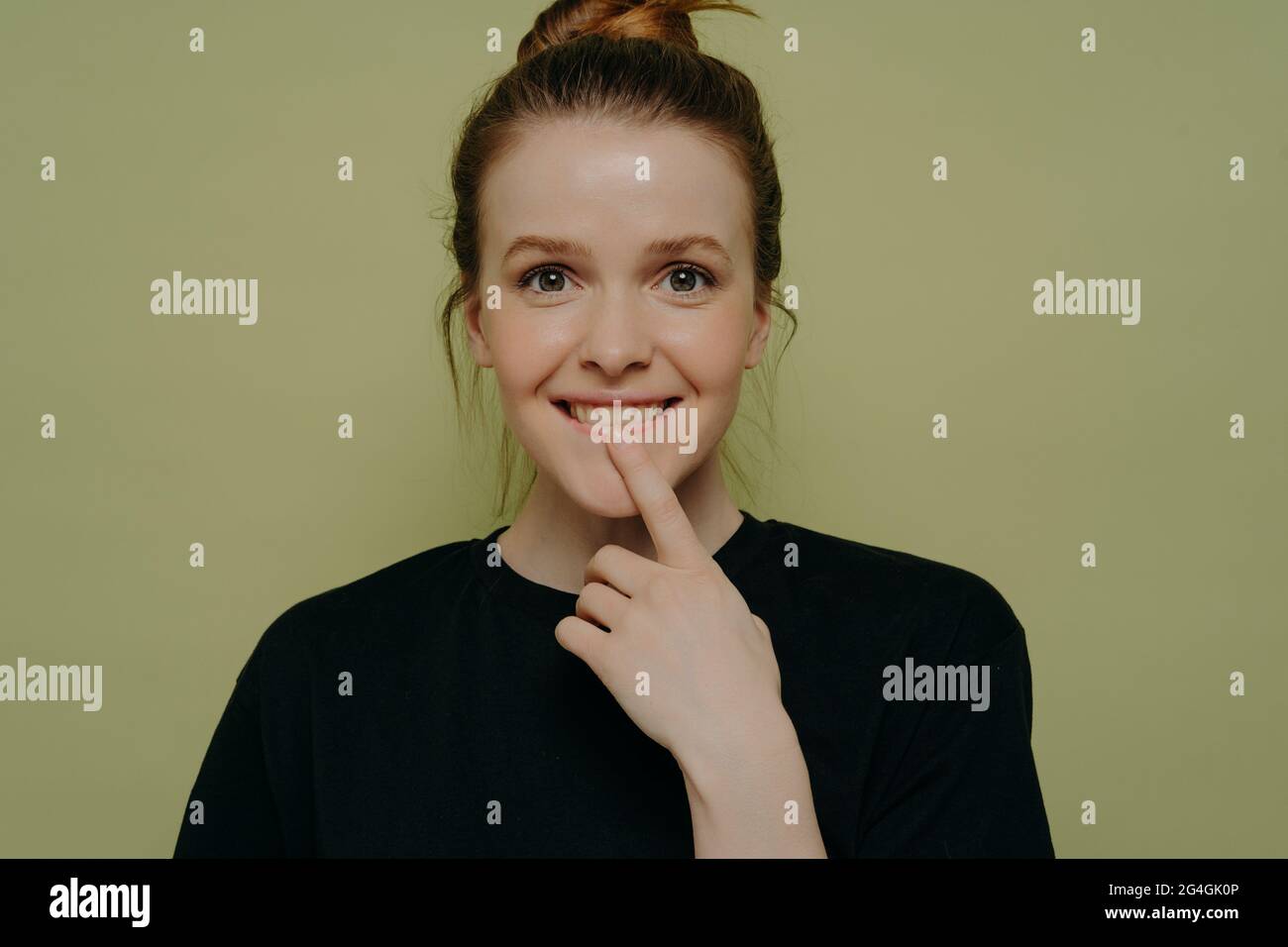 ?ute thoughtful teenage girl biting lower lip while posing in studio ...
