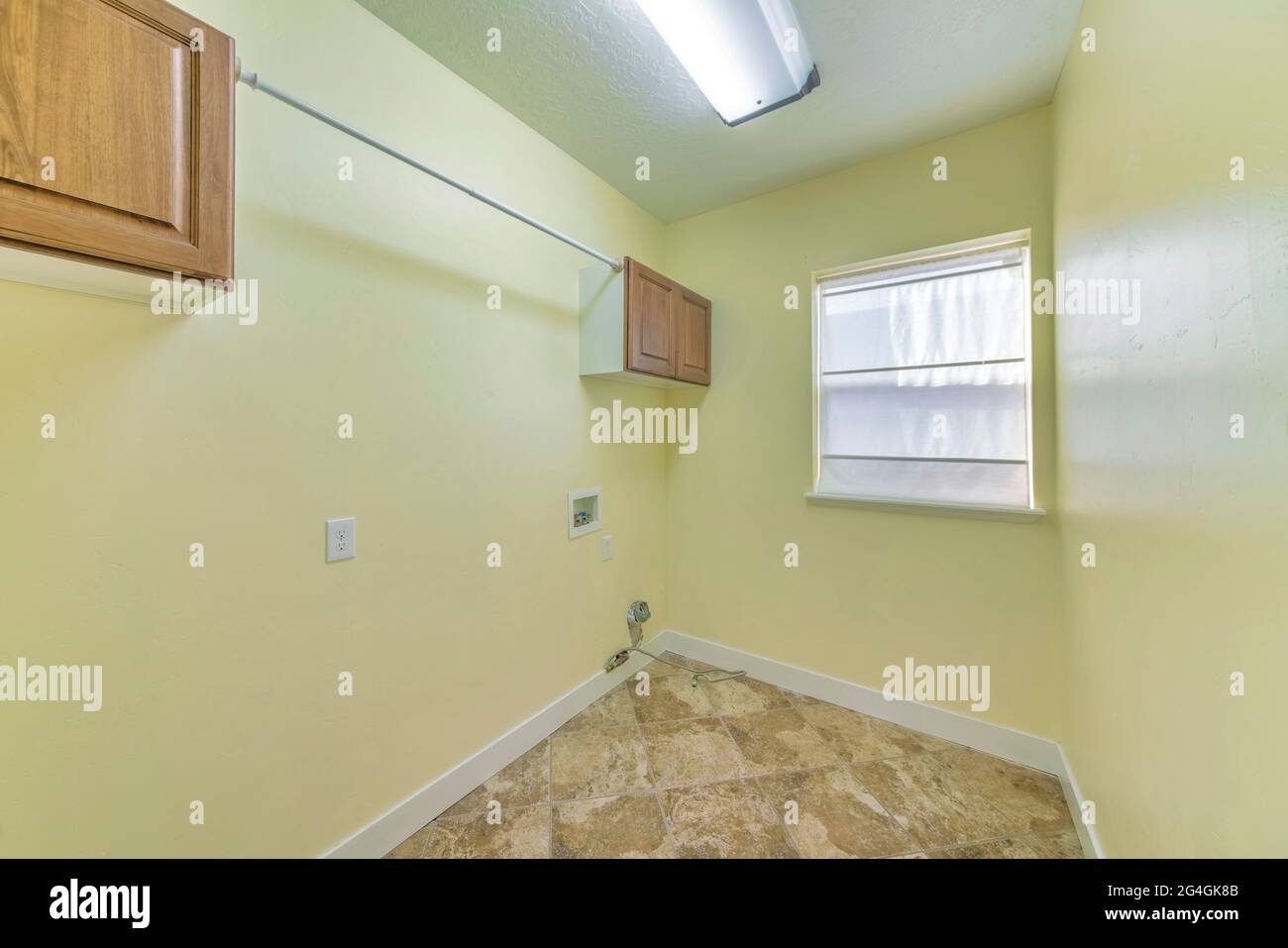 An empty room with shelves on yellow walls and tiled floor Stock Photo ...