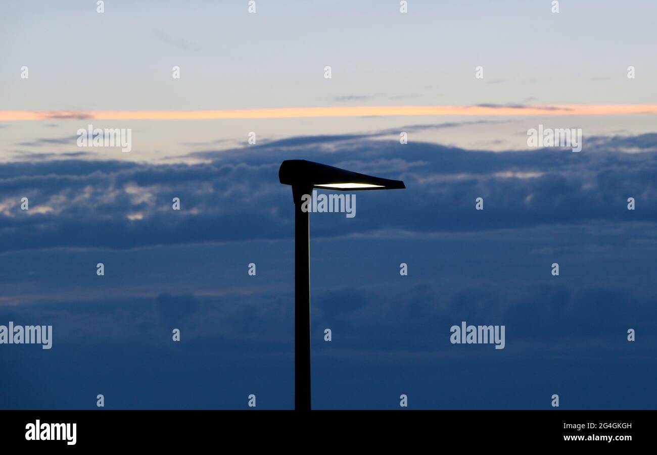 Isolated head of an led powered street lamp post at dusk Stock Photo ...