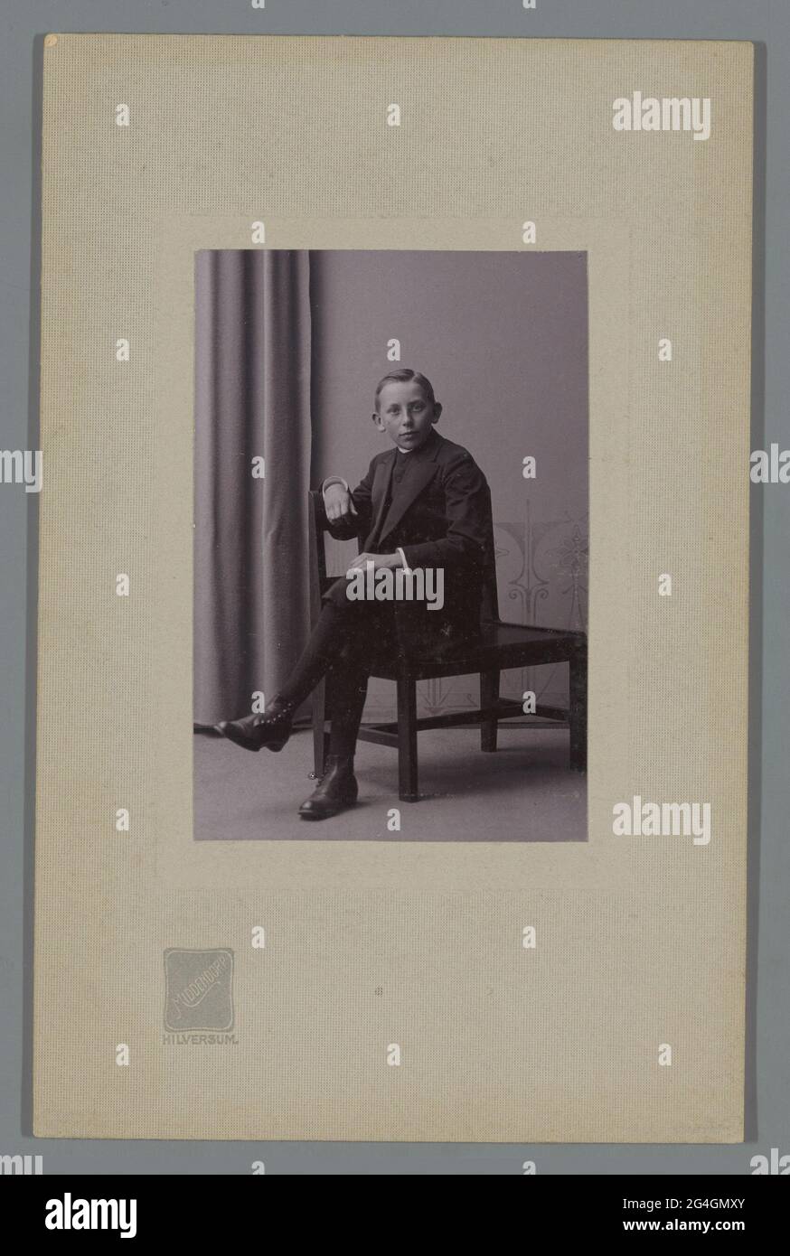 Portrait of an unknown boy on a chair Stock Photo - Alamy
