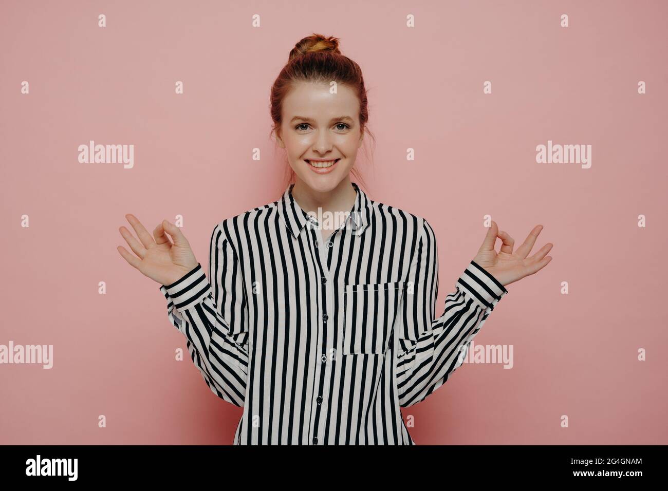 Happy ginger woman making okay gesture or meditating Stock Photo - Alamy