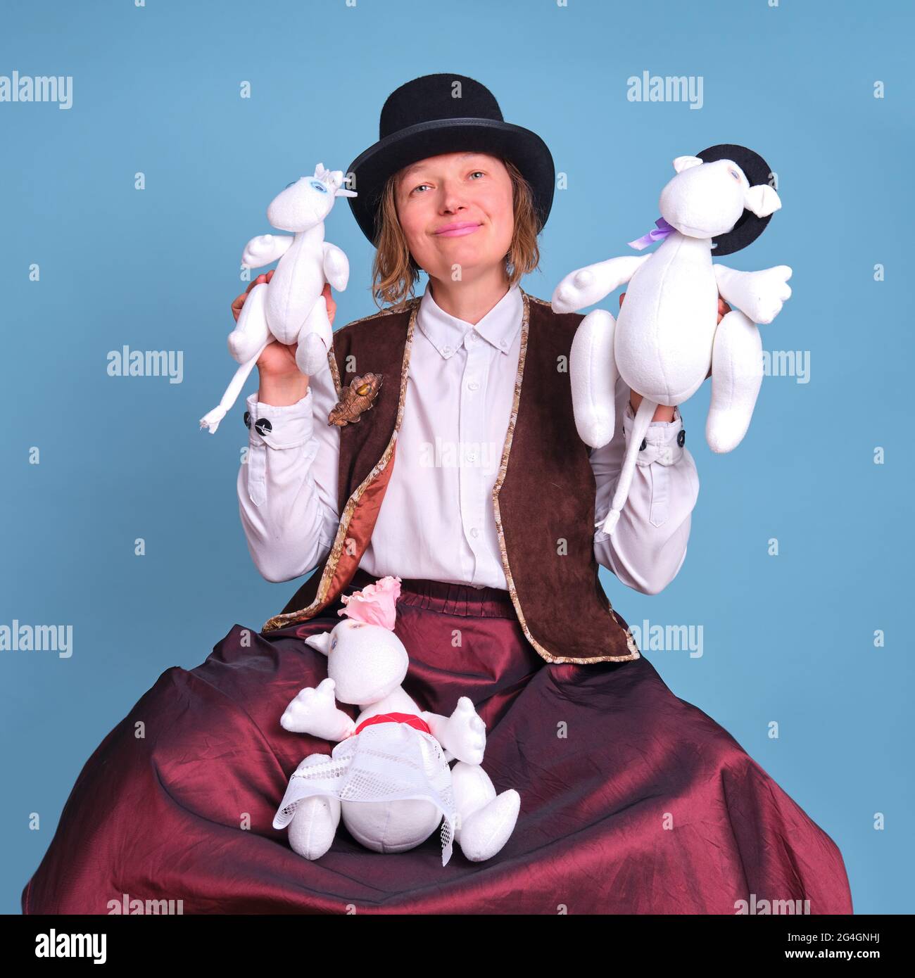 Actors with Moomin troll dolls on a blue background - Moscow, Russia ...