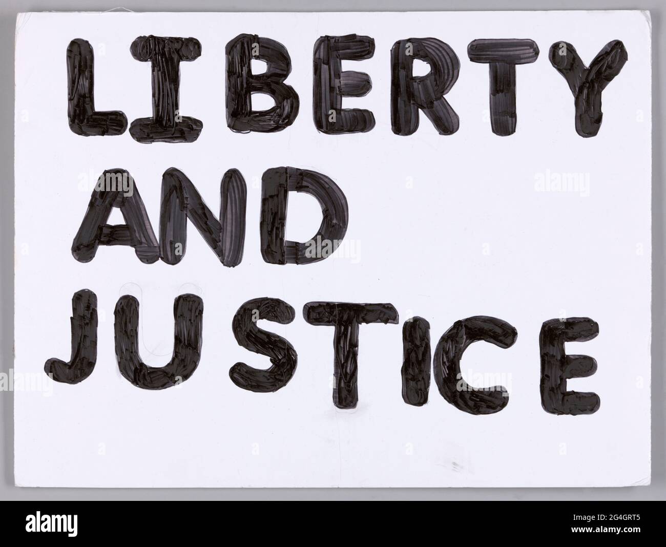 This cardboard sign is a rectangular piece of cardboard with ...