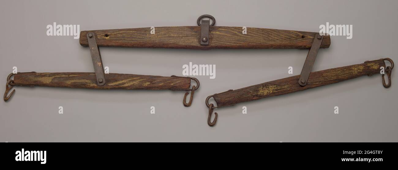 A doubletree harness consisting of a wood evener bar (central piece ...