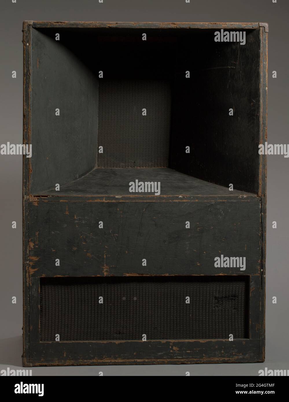 A rectangular speaker and painted black. The top of the front of the ...