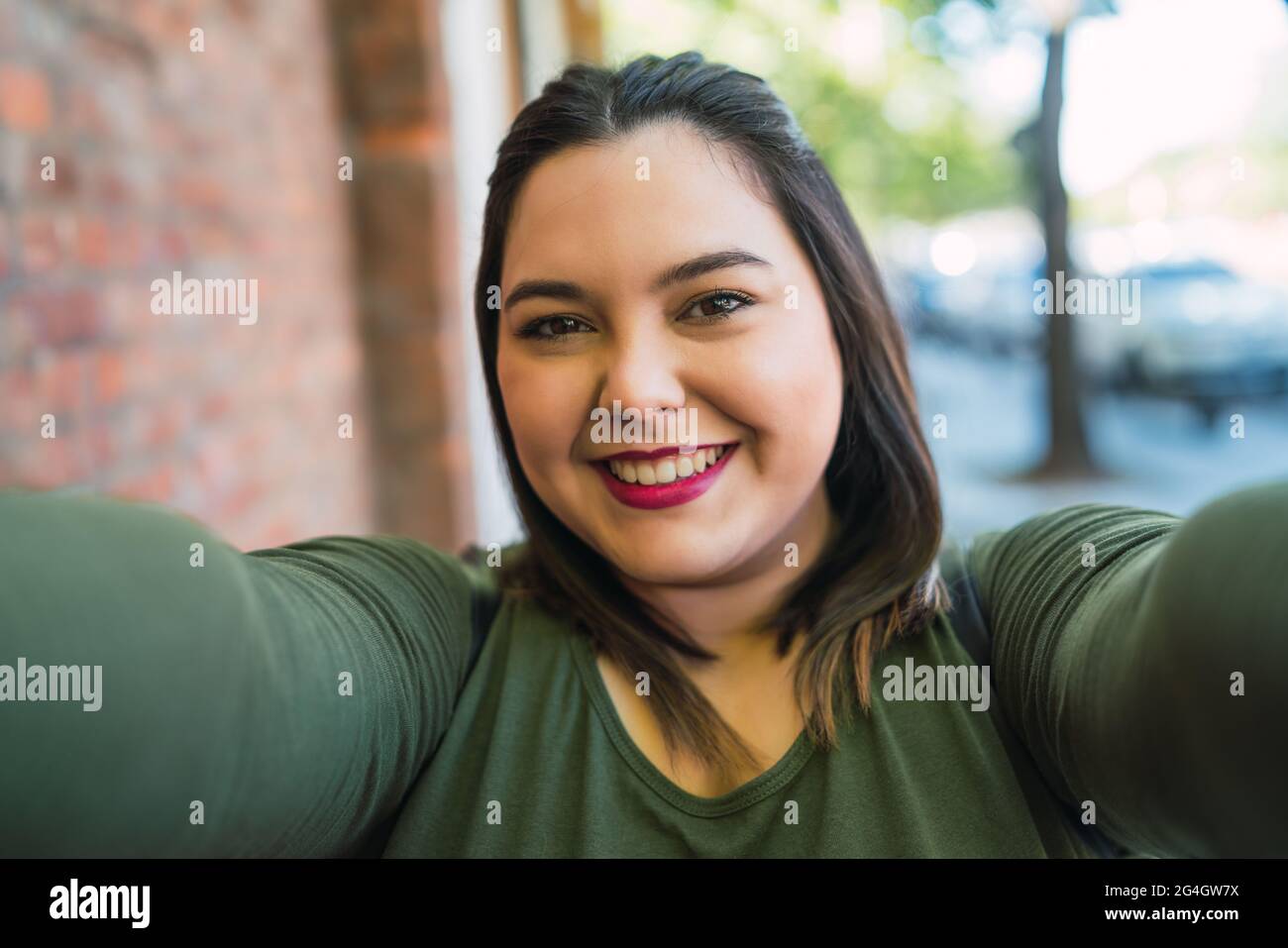 Young plus size woman taking a selfie Stock Photo - Alamy