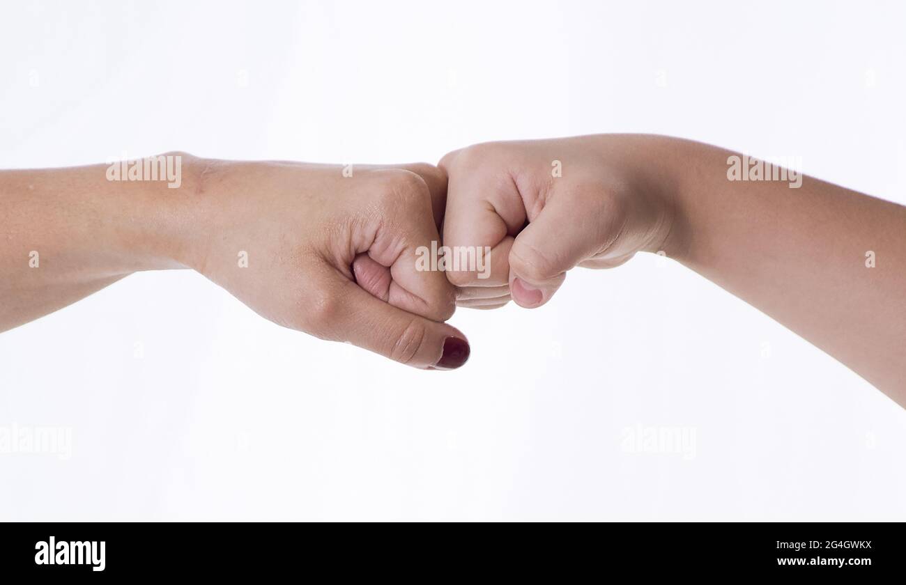 Female and a kid doing fist bump on a white background Stock Photo - Alamy