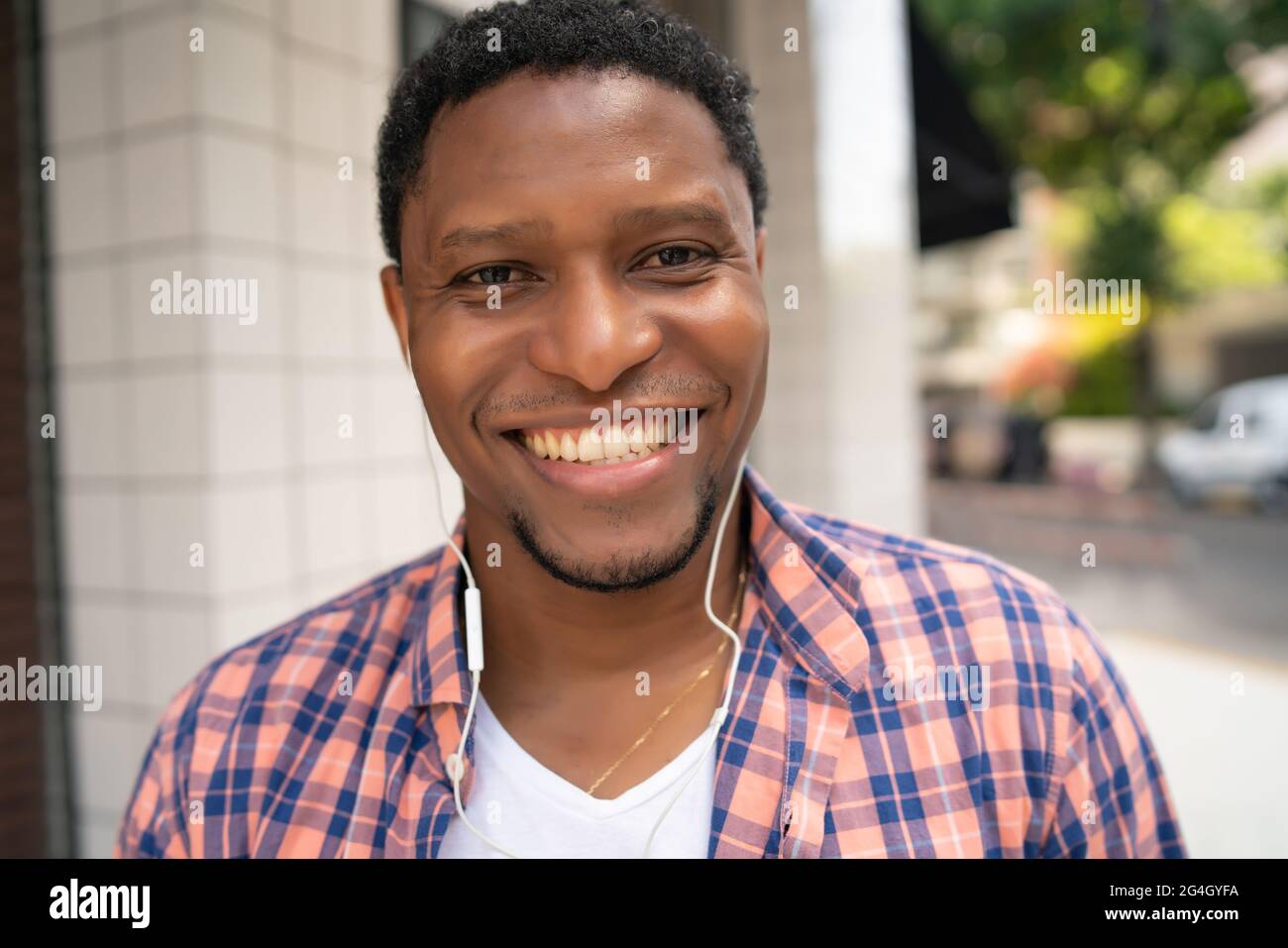 Man listening music with earphones outdoors Stock Photo - Alamy