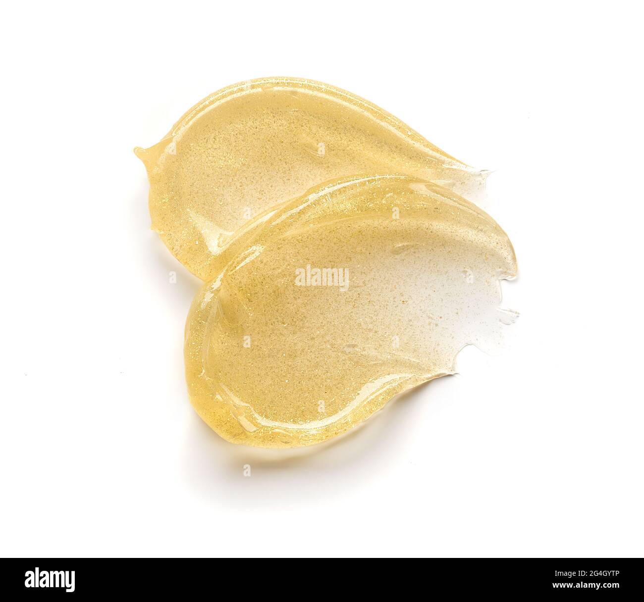 Transparent smear and texture of golden cosmetic gel on a white ...