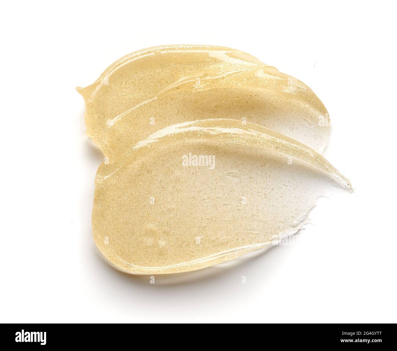 Transparent smear and texture of golden cosmetic gel on a white ...