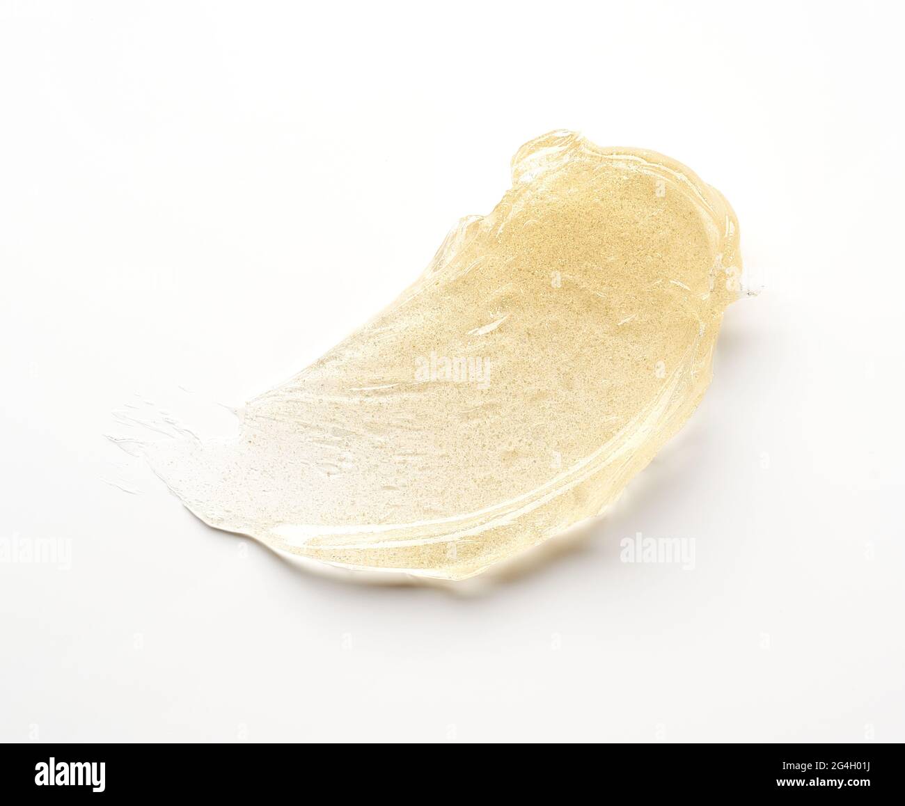 Transparent smear and texture of golden cosmetic gel on a white ...