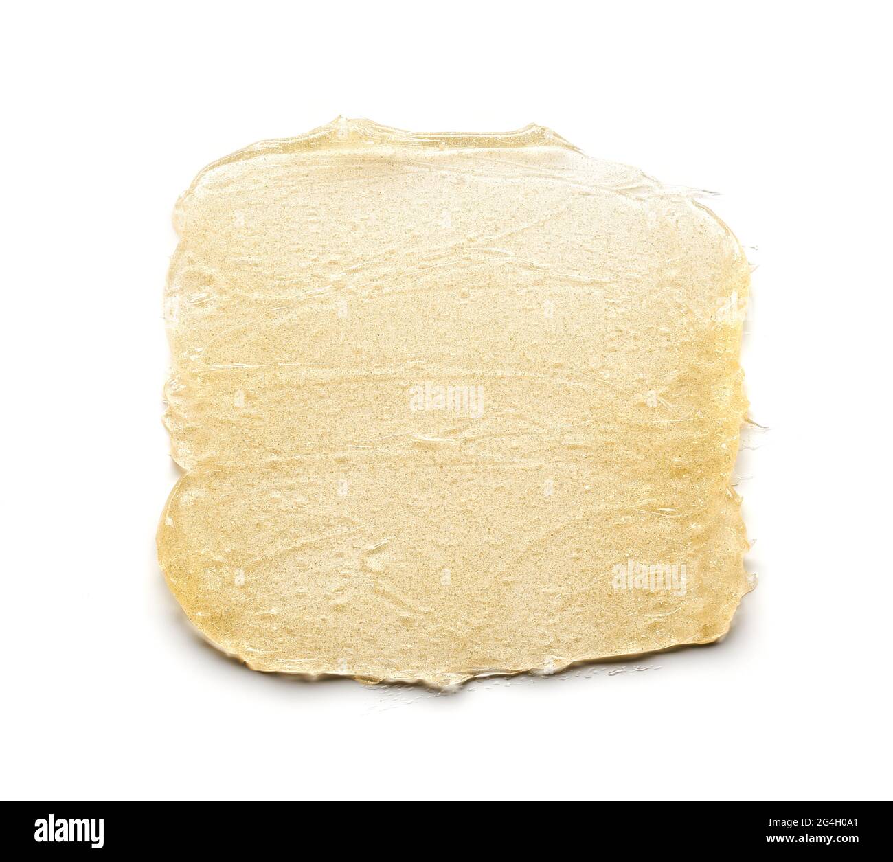 Transparent smear and texture of golden cosmetic gel on a white ...