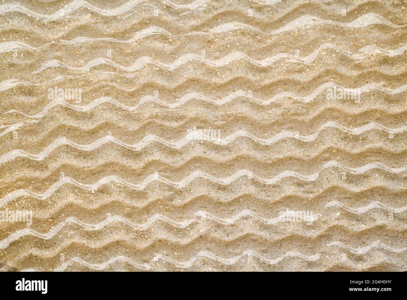 Transparent smear and texture of golden cosmetic gel on a white ...