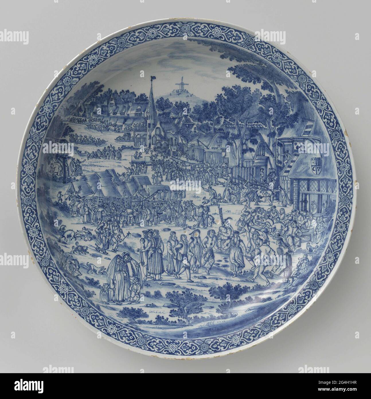 . Dish of faience, painted in blue with a village fair, on the edge ...