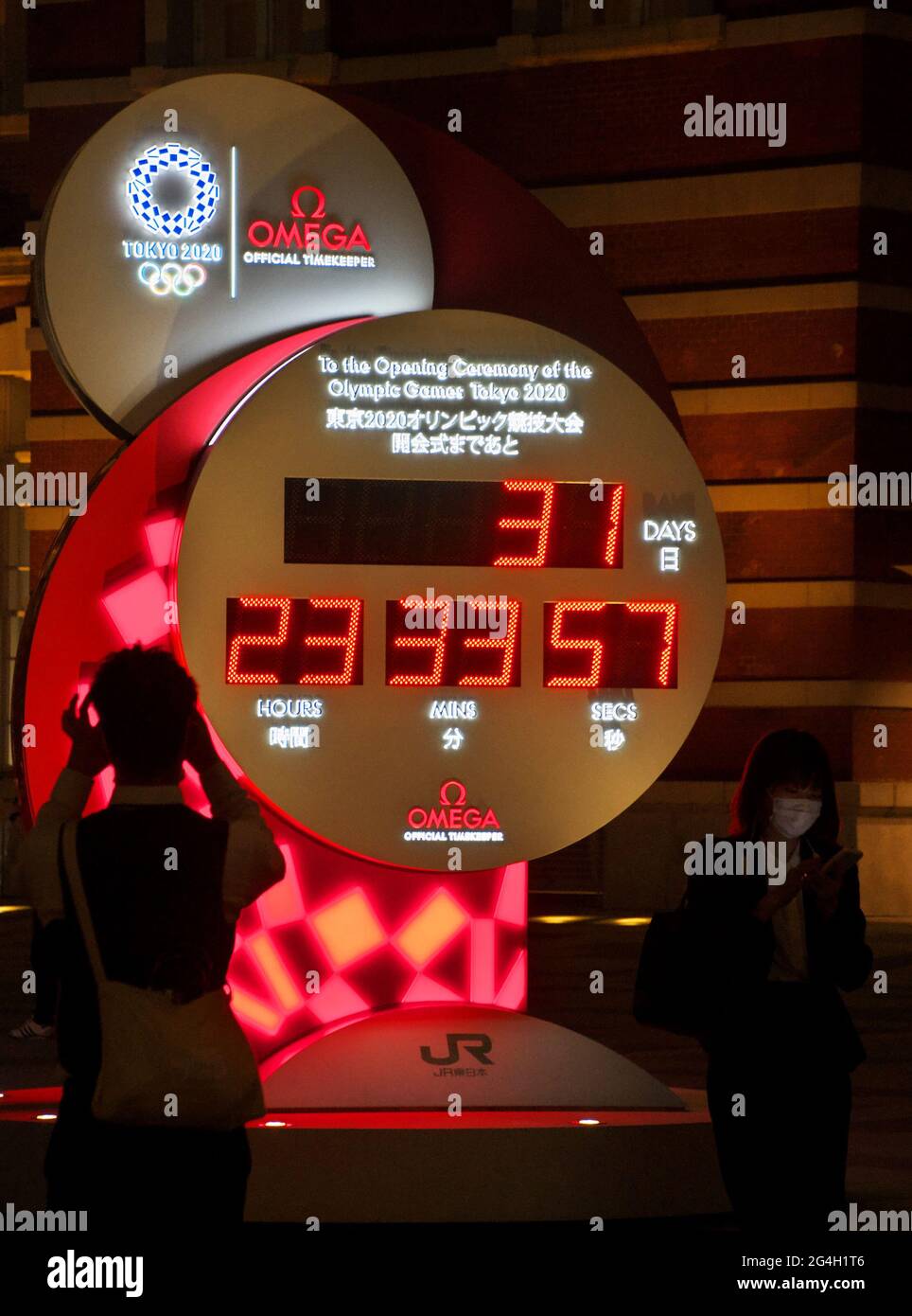 Tokyo, Japan. 21st June, 2021. Pedestrian take a photo big countdown ...