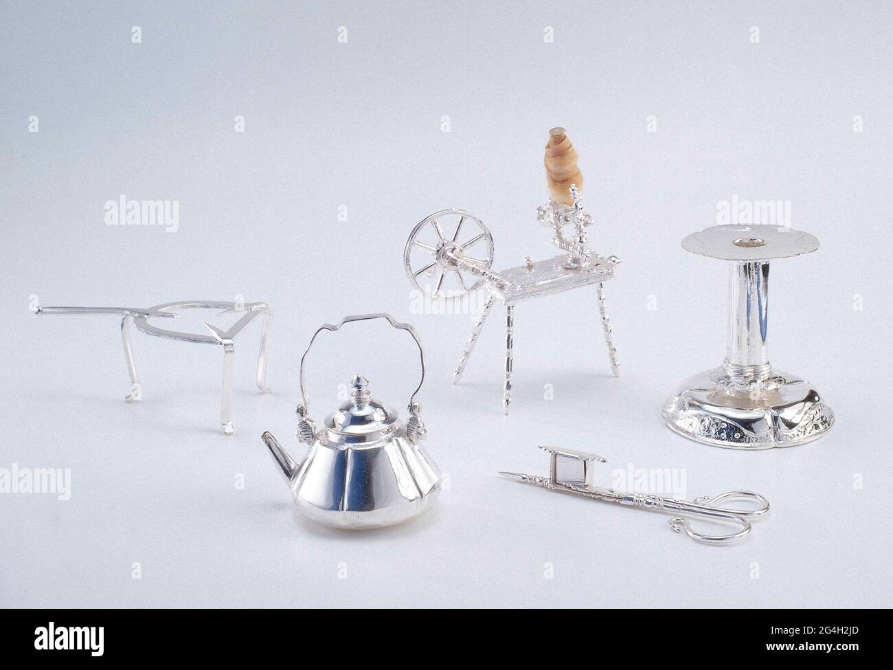 . Spinning wheel of silver, on three legs. Styles and rules with ...