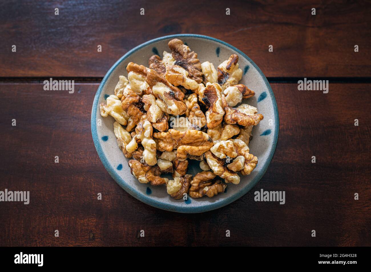 Small bowl of cracked walnuts for snack Stock Photo - Alamy