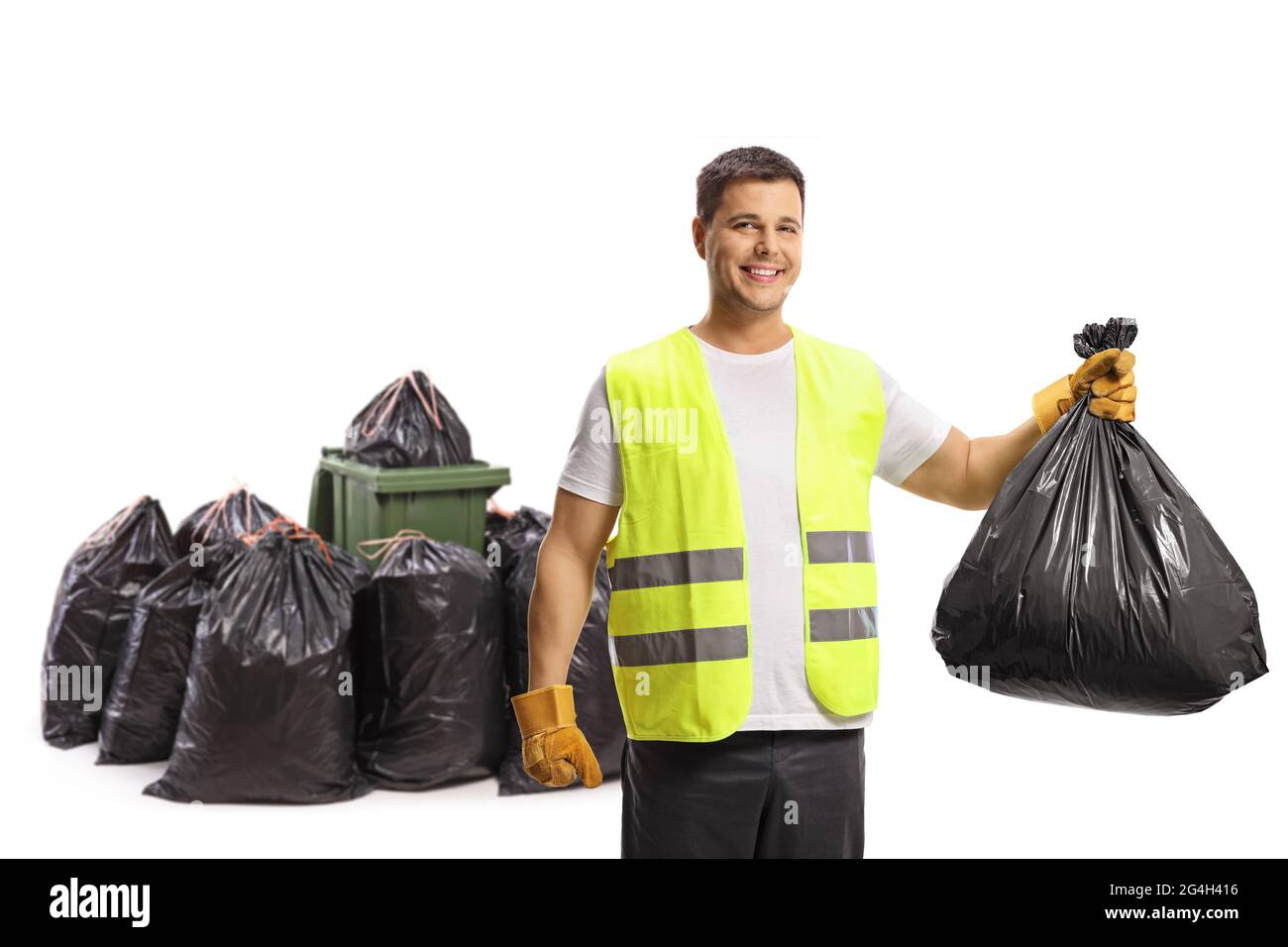 Waste collector holding a plastic bag in front of a bin and a pile of ...