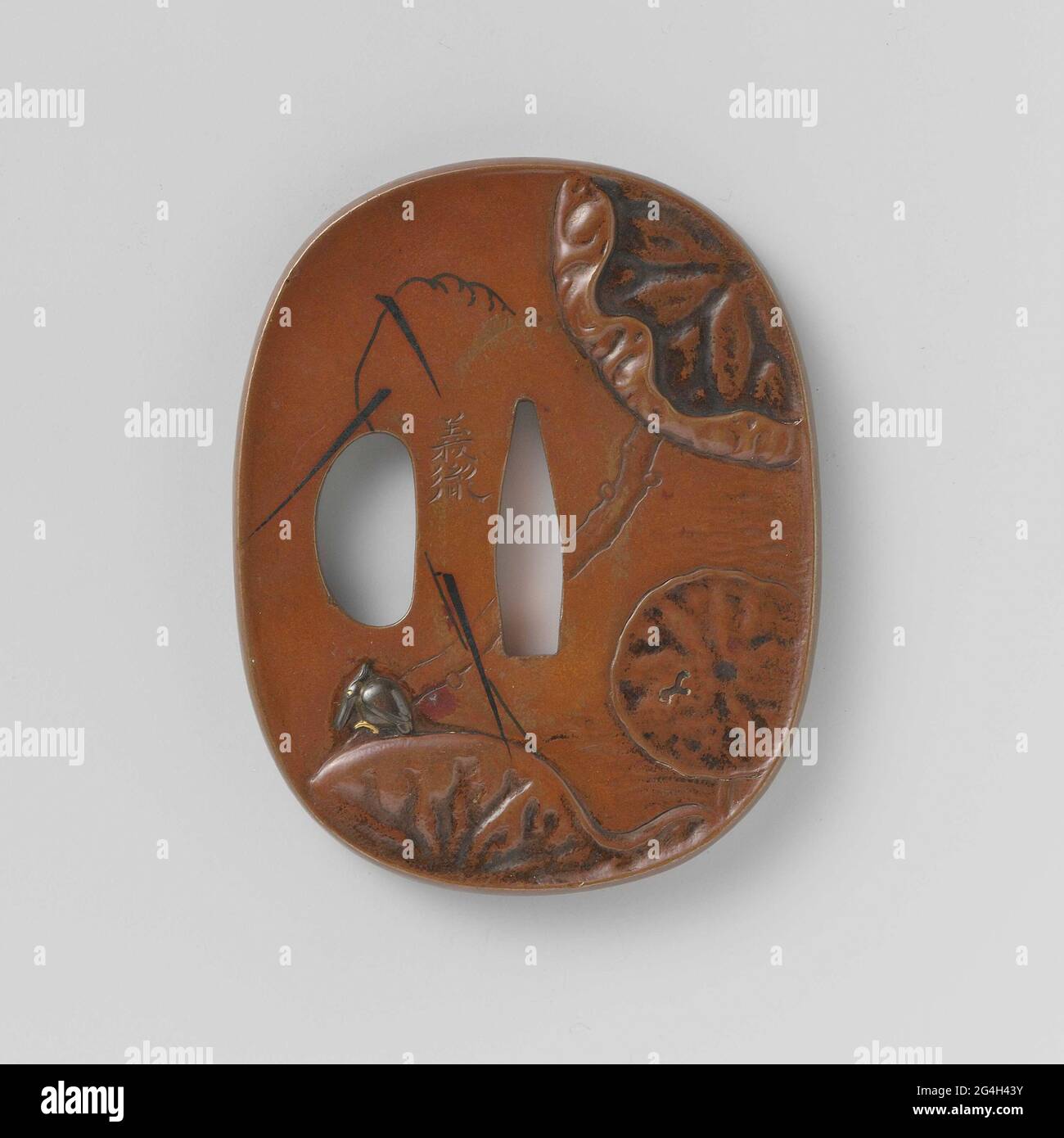 . Rounded rectangular tsuba with elevated edge; on one side lotus ...