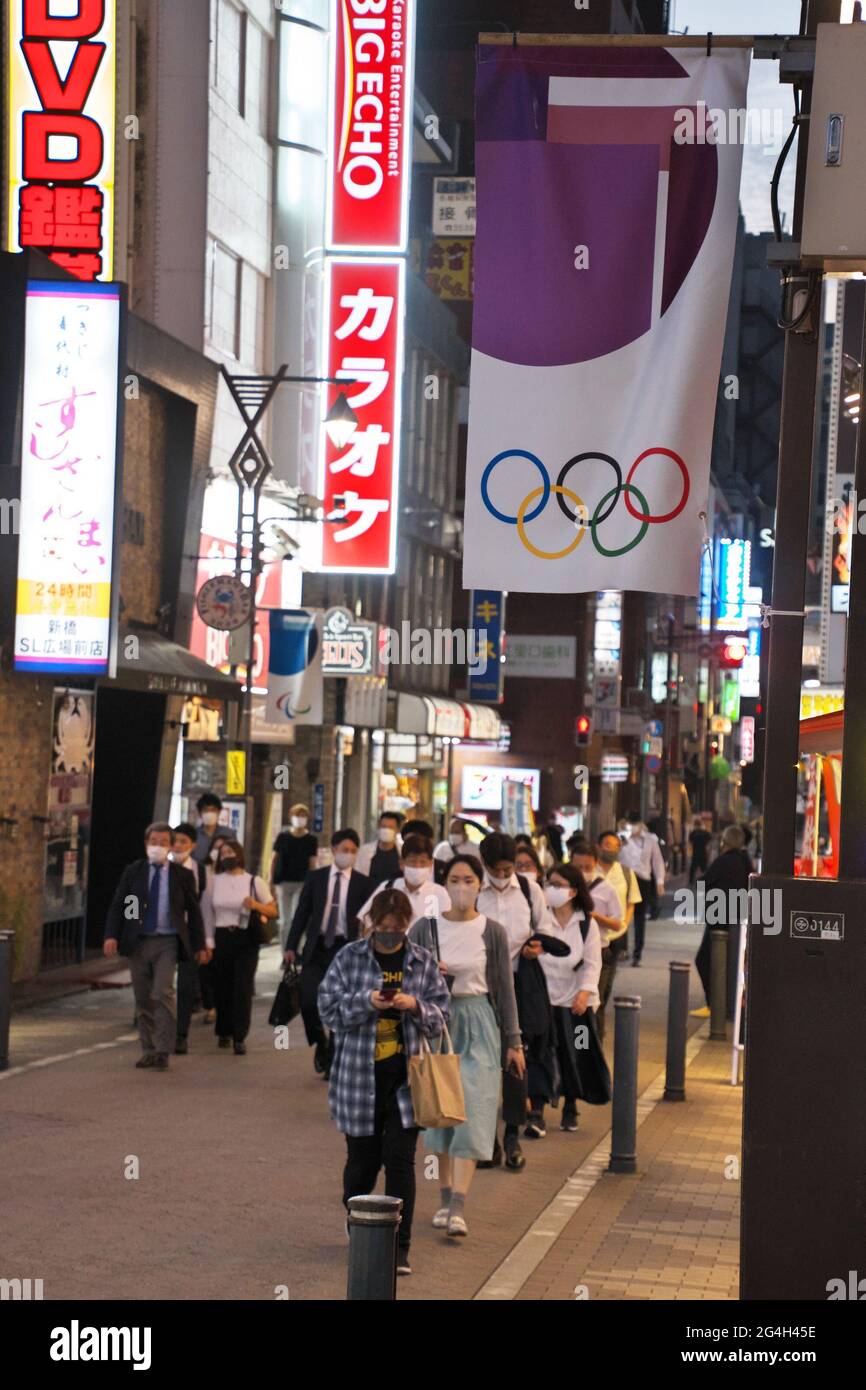 Tokyo, Japan. 21st June, 2021. Pedestrians wearing face masks walk in ...