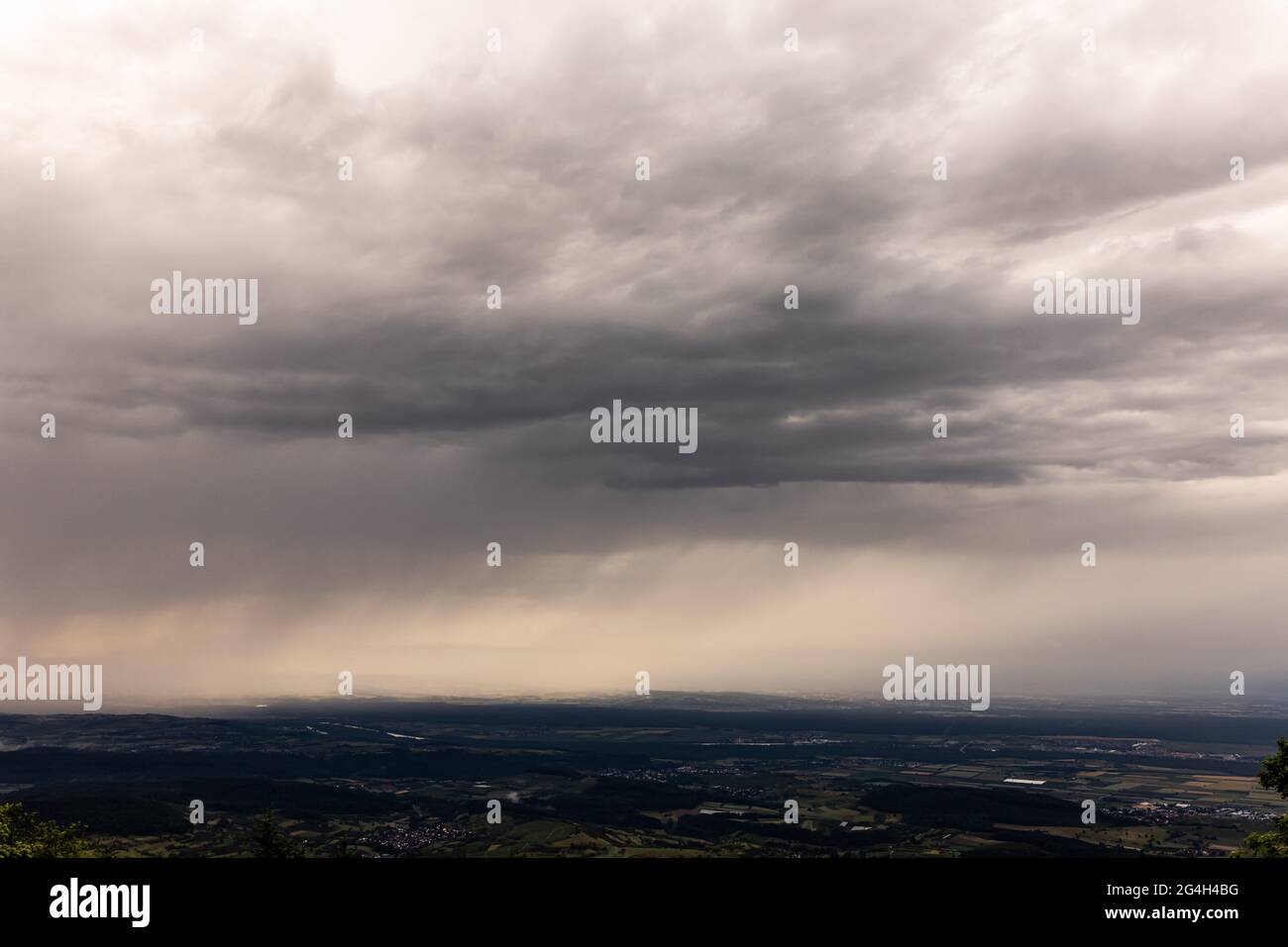 Schliengen, Germany. 21st June, 2021. A rain cloud empties over the ...