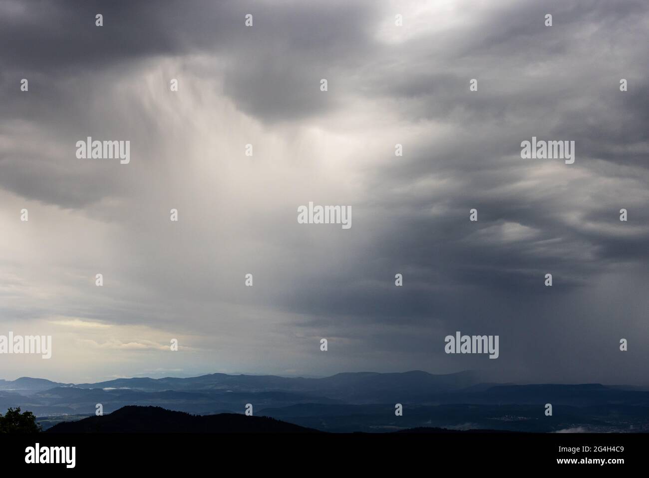 Schliengen, Germany. 21st June, 2021. A rain cloud empties over the ...