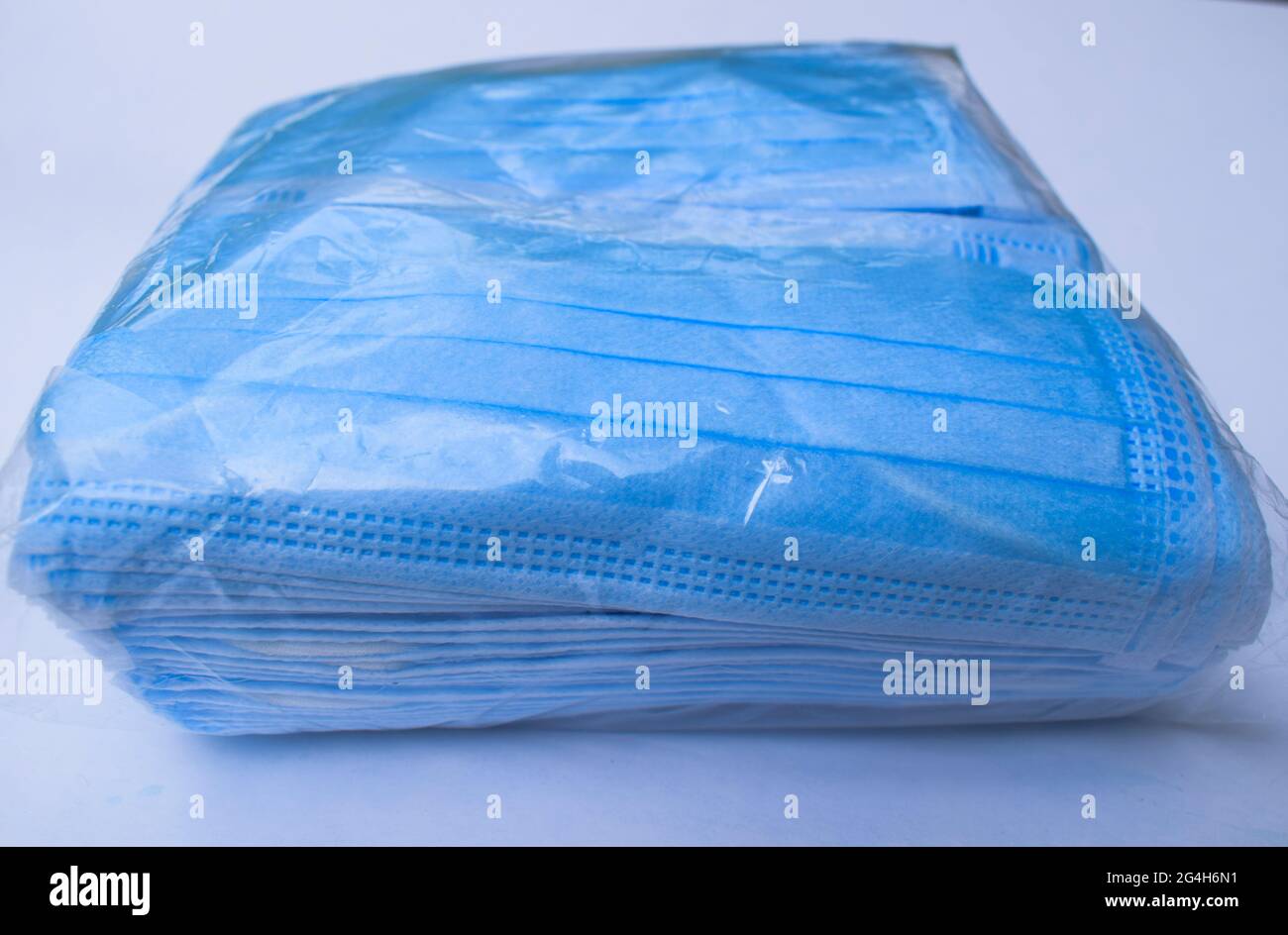 Package of many blue disposable surgical masks. Bundle pack of surgical ...