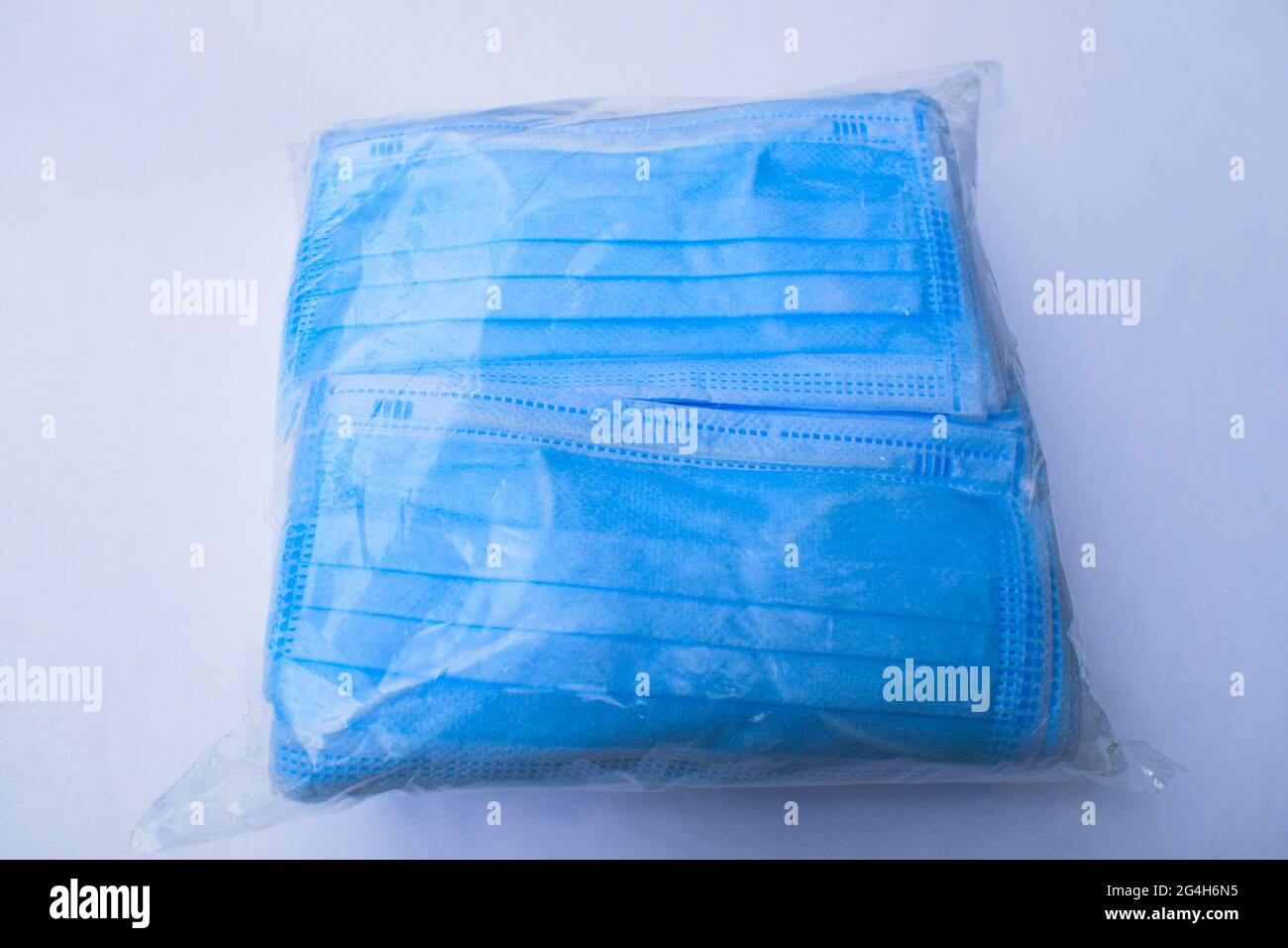 Package of many blue disposable surgical masks. Bundle pack of surgical ...