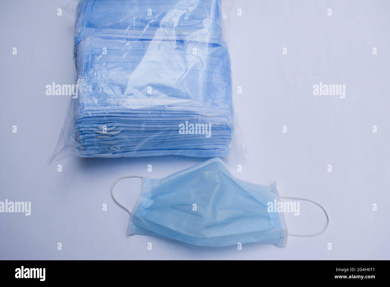 Package of many blue disposable surgical masks. Bundle pack of surgical ...