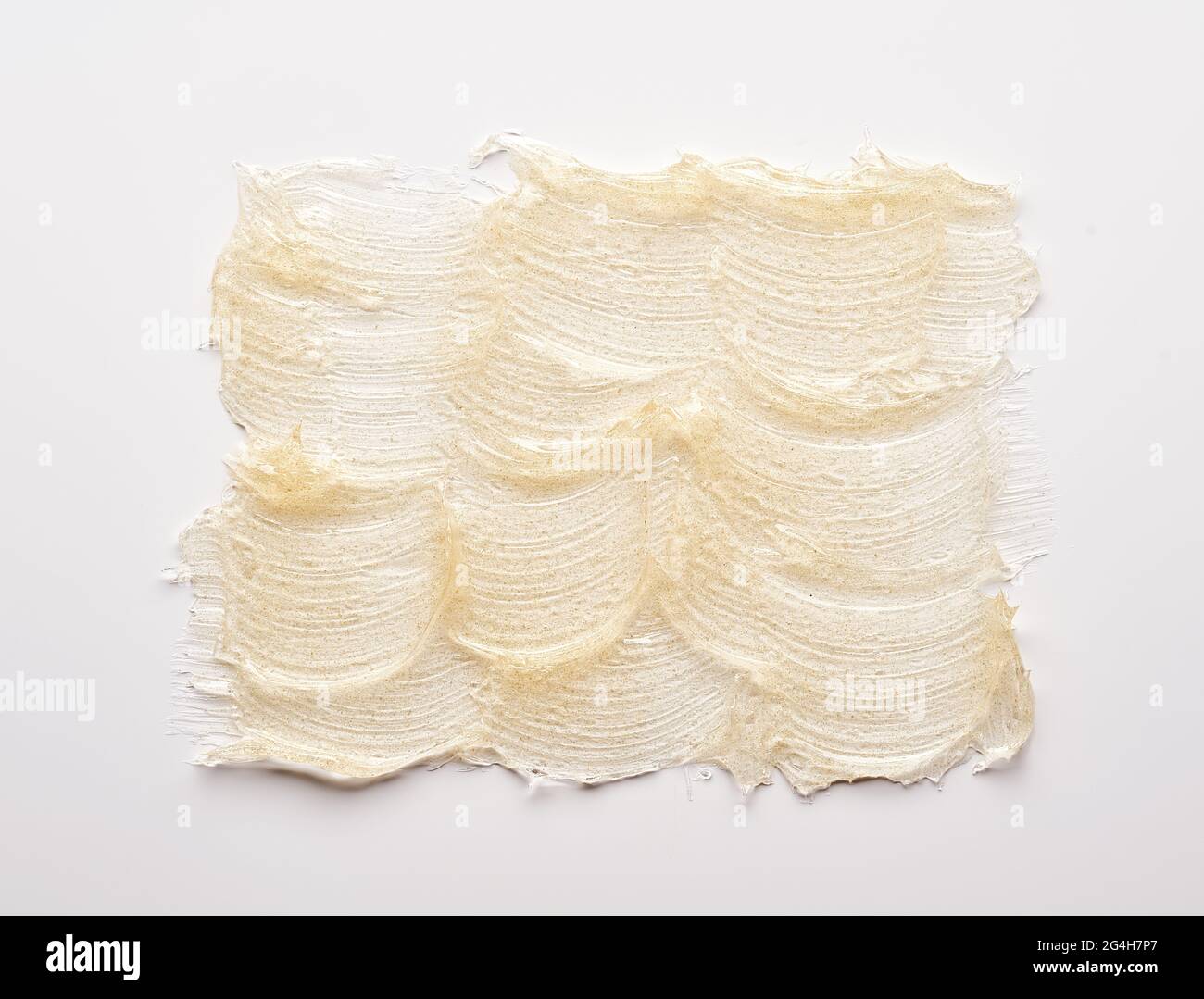 Transparent smear and texture of golden cosmetic gel on a white ...