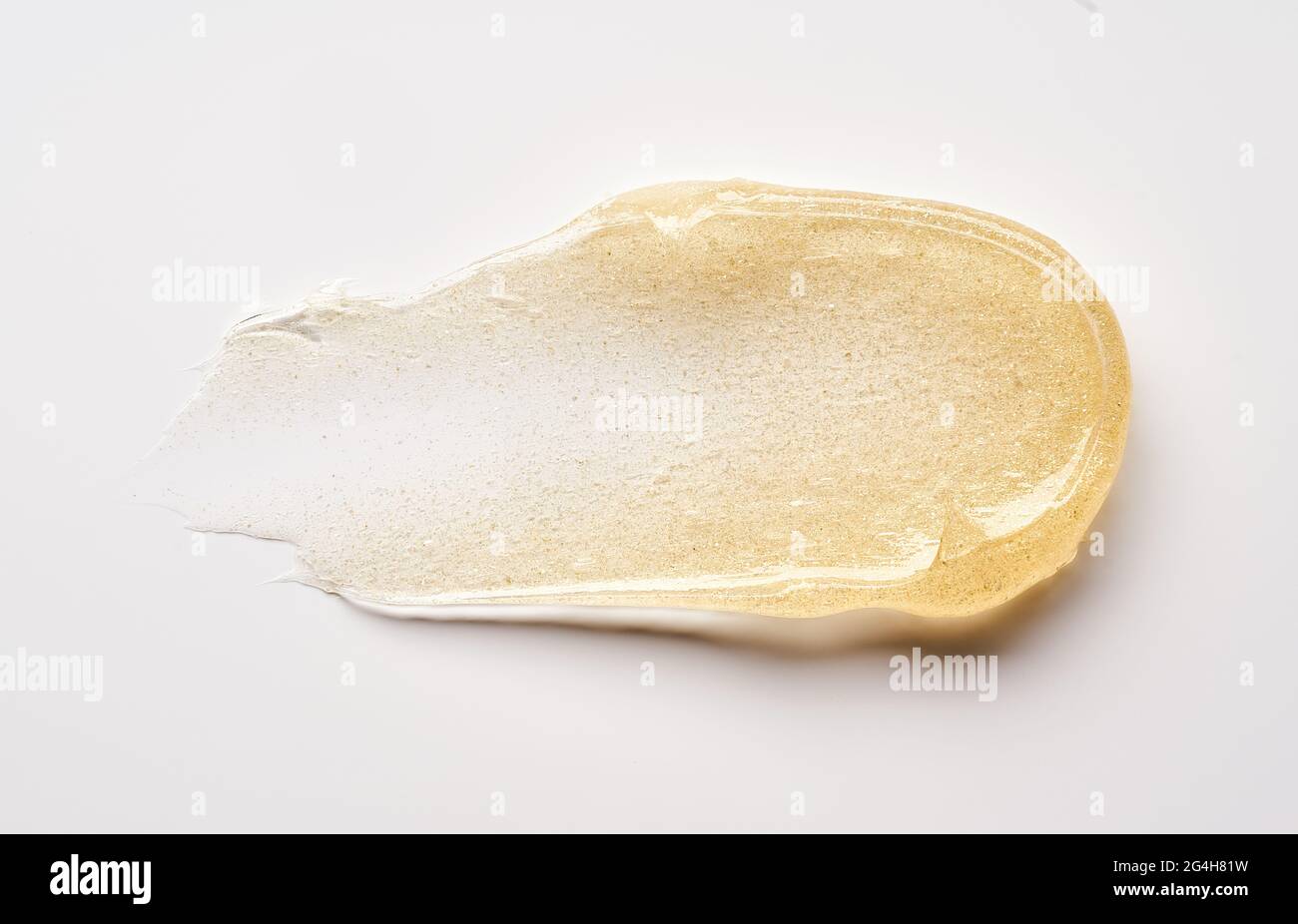 Transparent smear and texture of golden cosmetic gel on a white ...