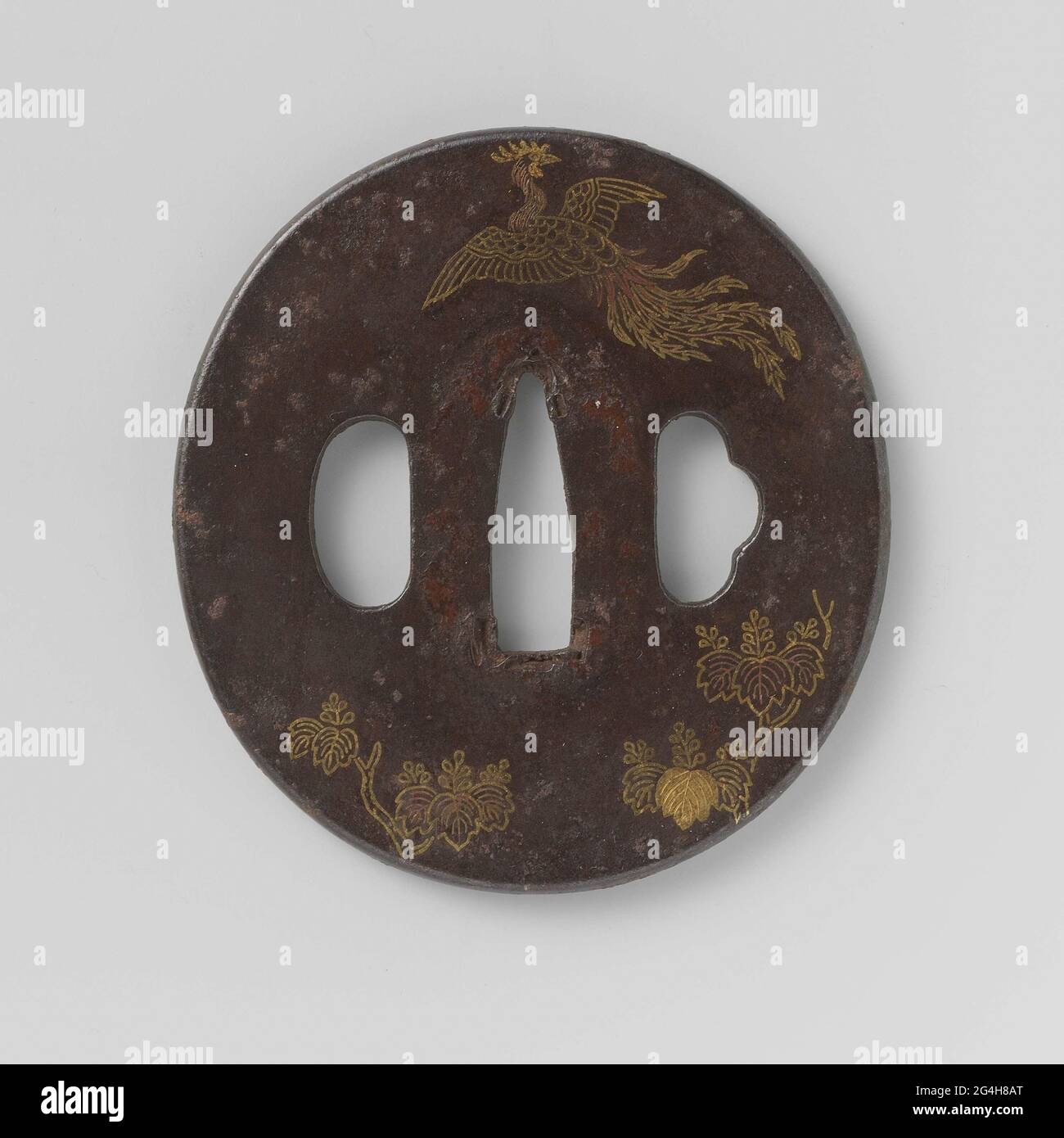 . Oval Tsuba with a Phoenix and Paulownia branches at the front in flat ...