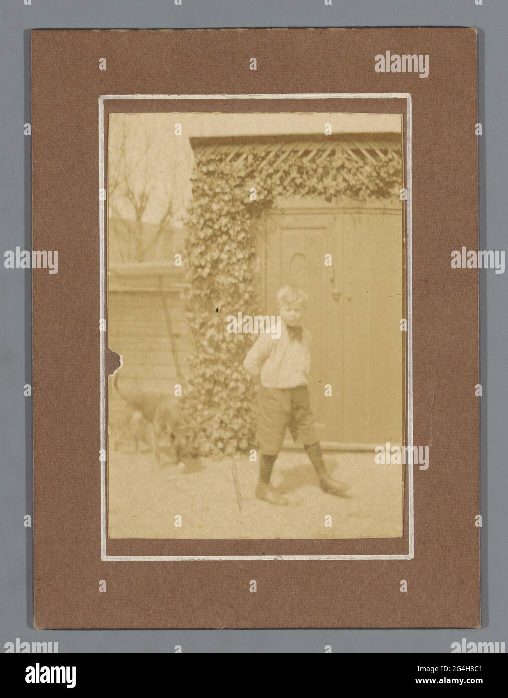 Portrait of an unknown boy in front of a shed Stock Photo - Alamy