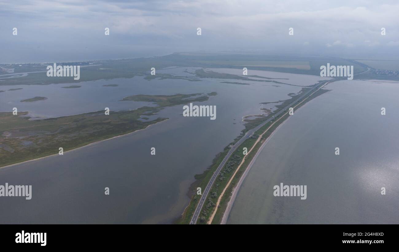 A highway that runs along a narrow spit between the sea and the estuary ...