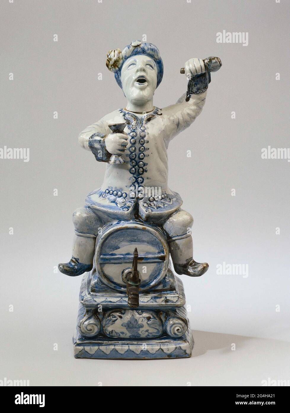 . Humorous drinking vessels in the shape of a guzzling figure seated on ...